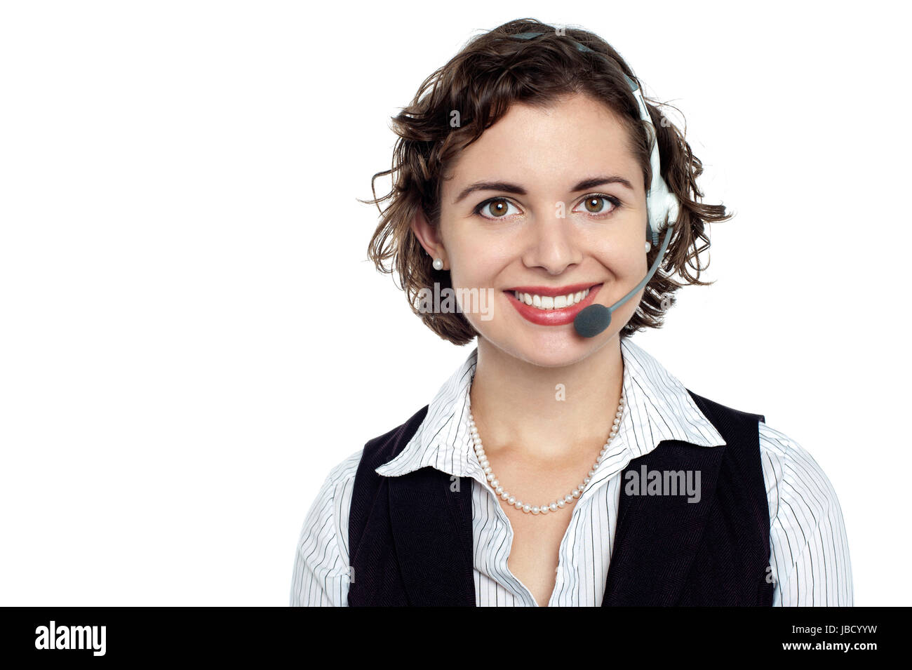 Attractive call centre executive assisting the customer, warm smile on ...