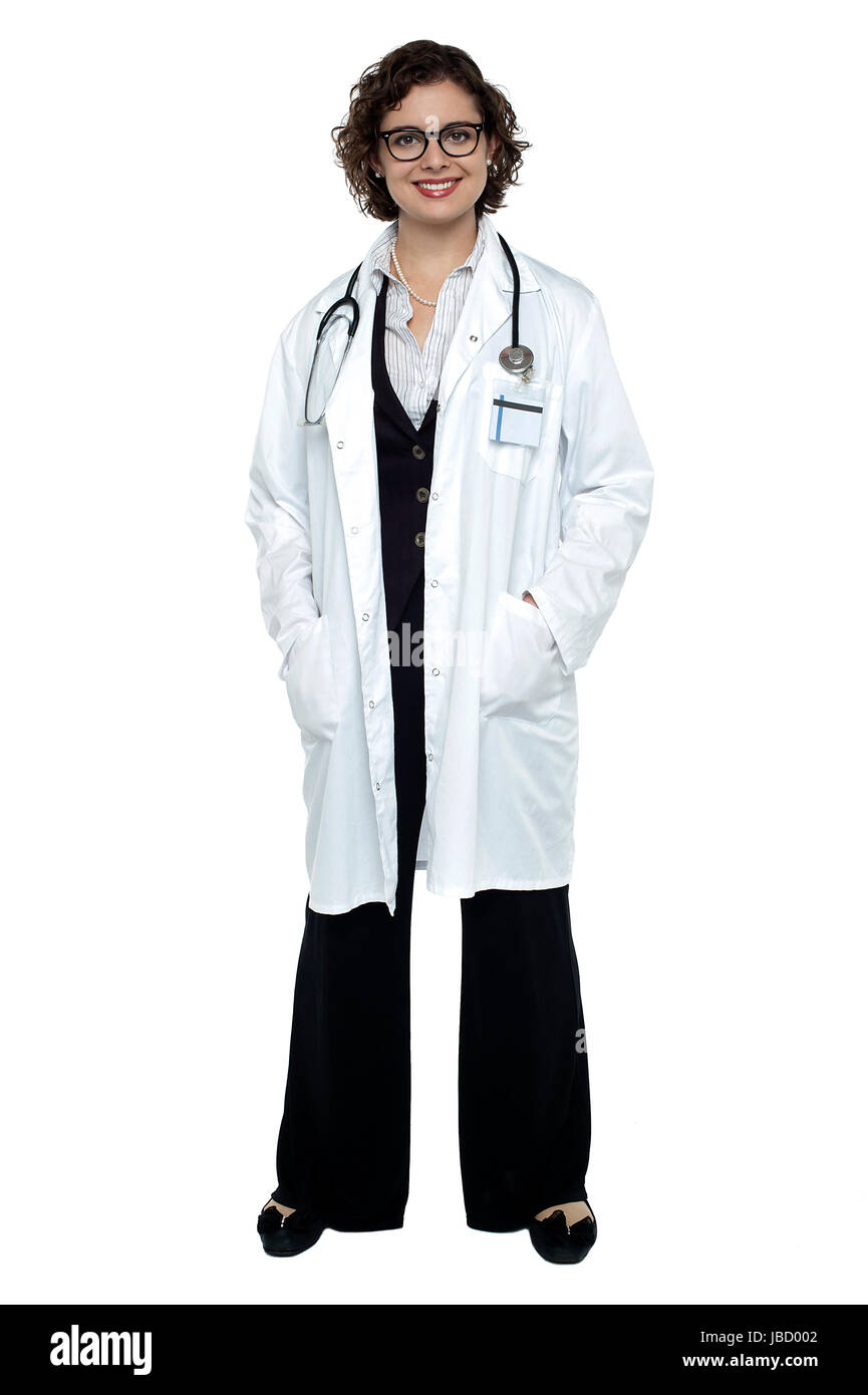 Full length portrait of a lovely female doctor posing against white ...