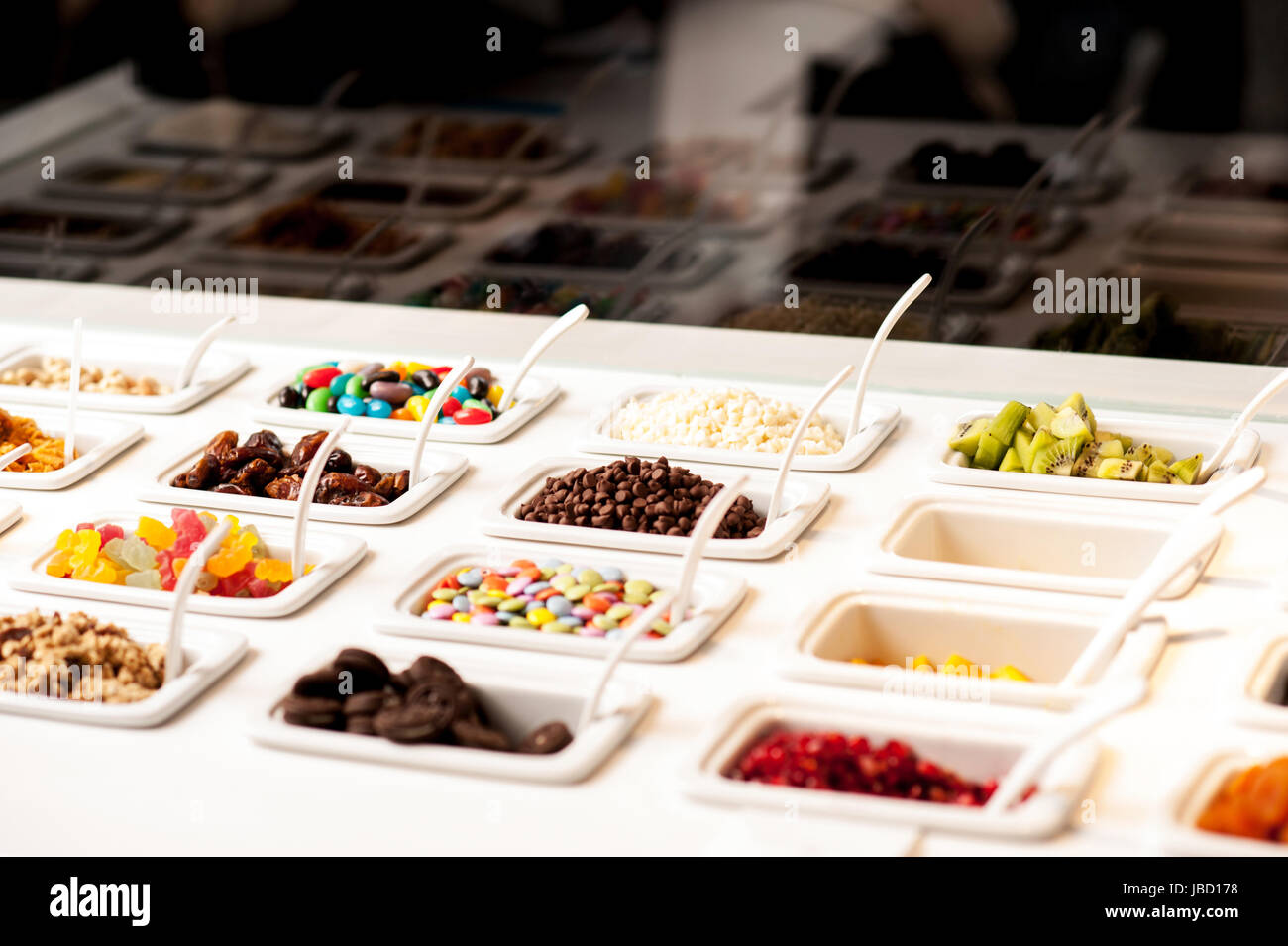 Variety of colorful toppings and yummy jellies displayed Stock Photo ...