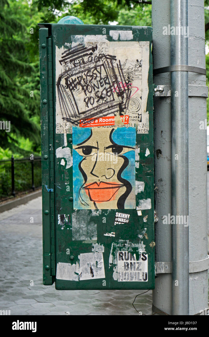 Stickers, drawings and graffiti on an electrical box just outside ...