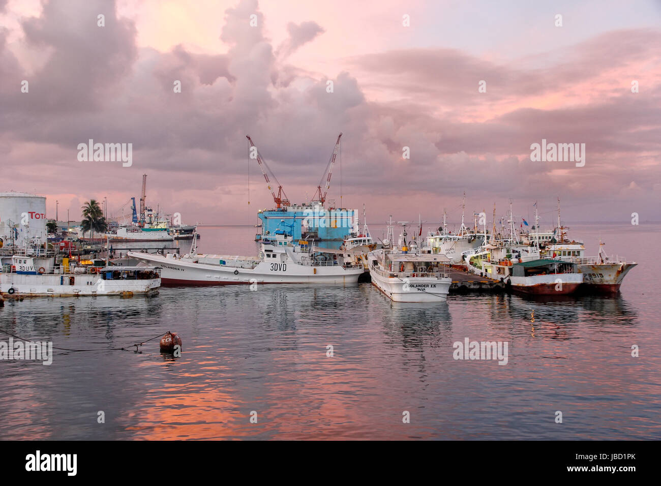 Boats at Suva port at sunrise, Viti Levu Island, Fiji. Suva is ...