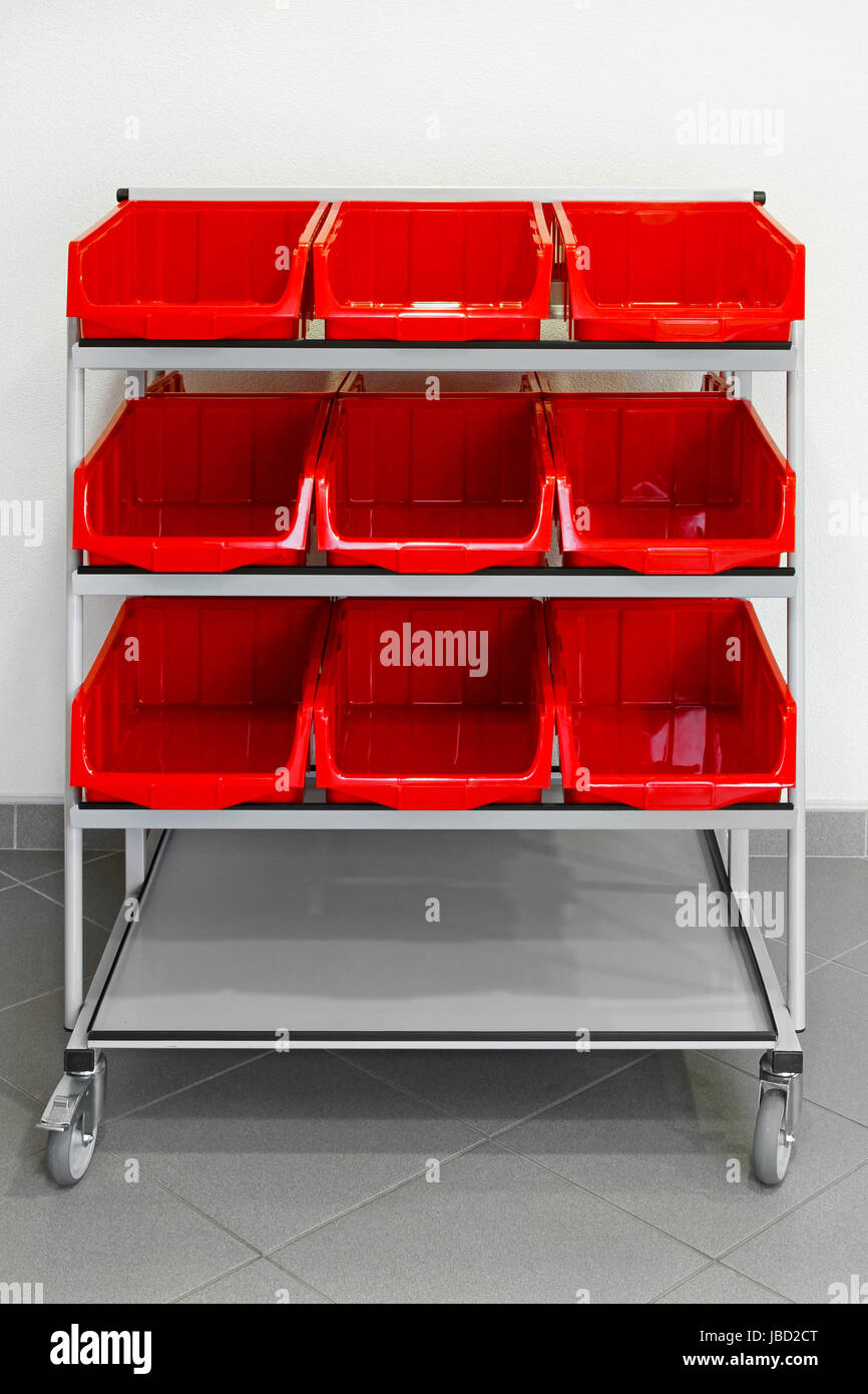 Supply cart with plastic red boxes for storehouse Stock Photo - Alamy