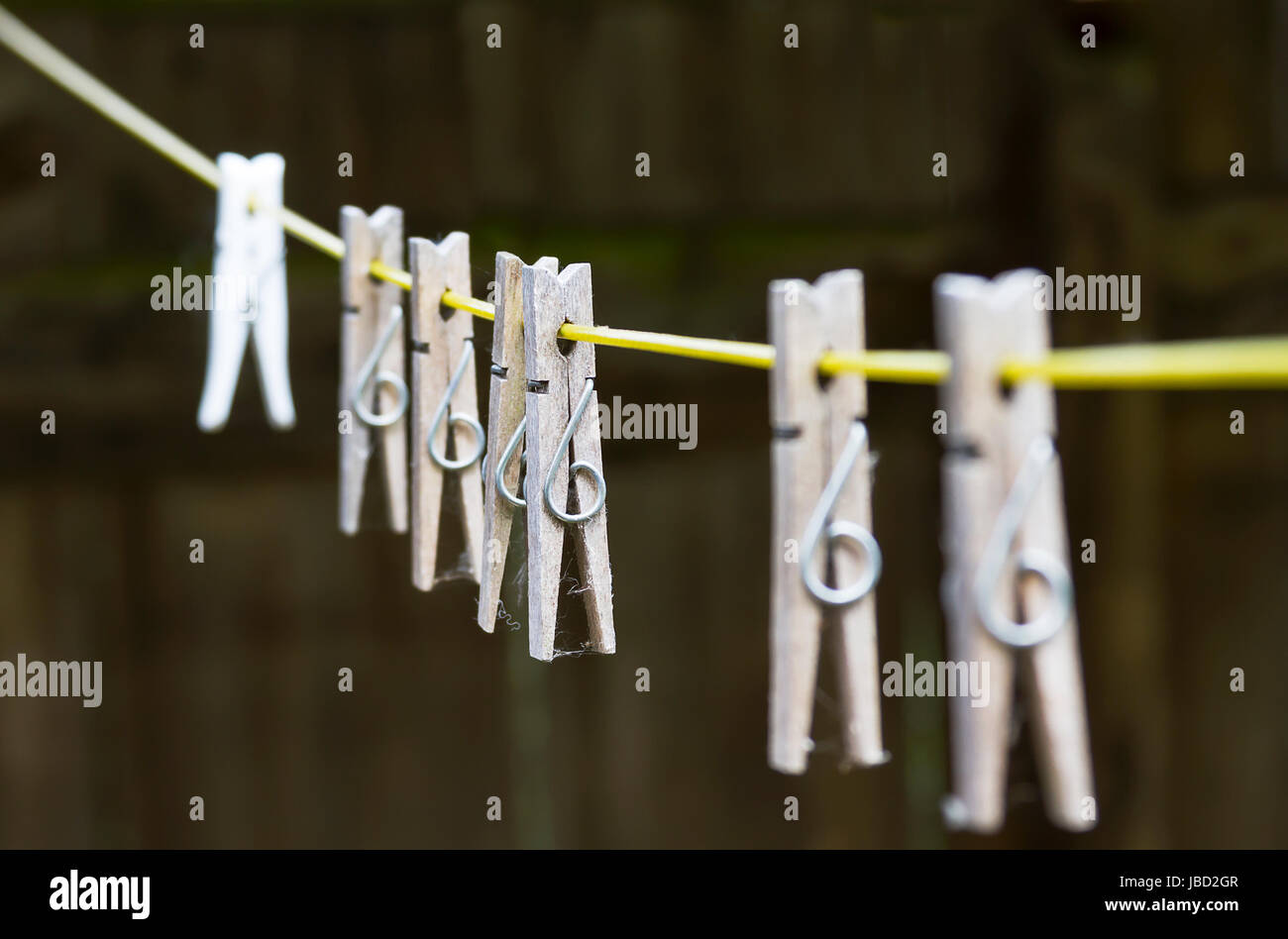 set of wooden pegs on washing line Stock Photo - Alamy