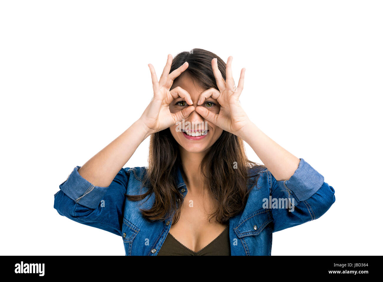 Beautiful woman making a silly face with hands on the eyes, isolated ...