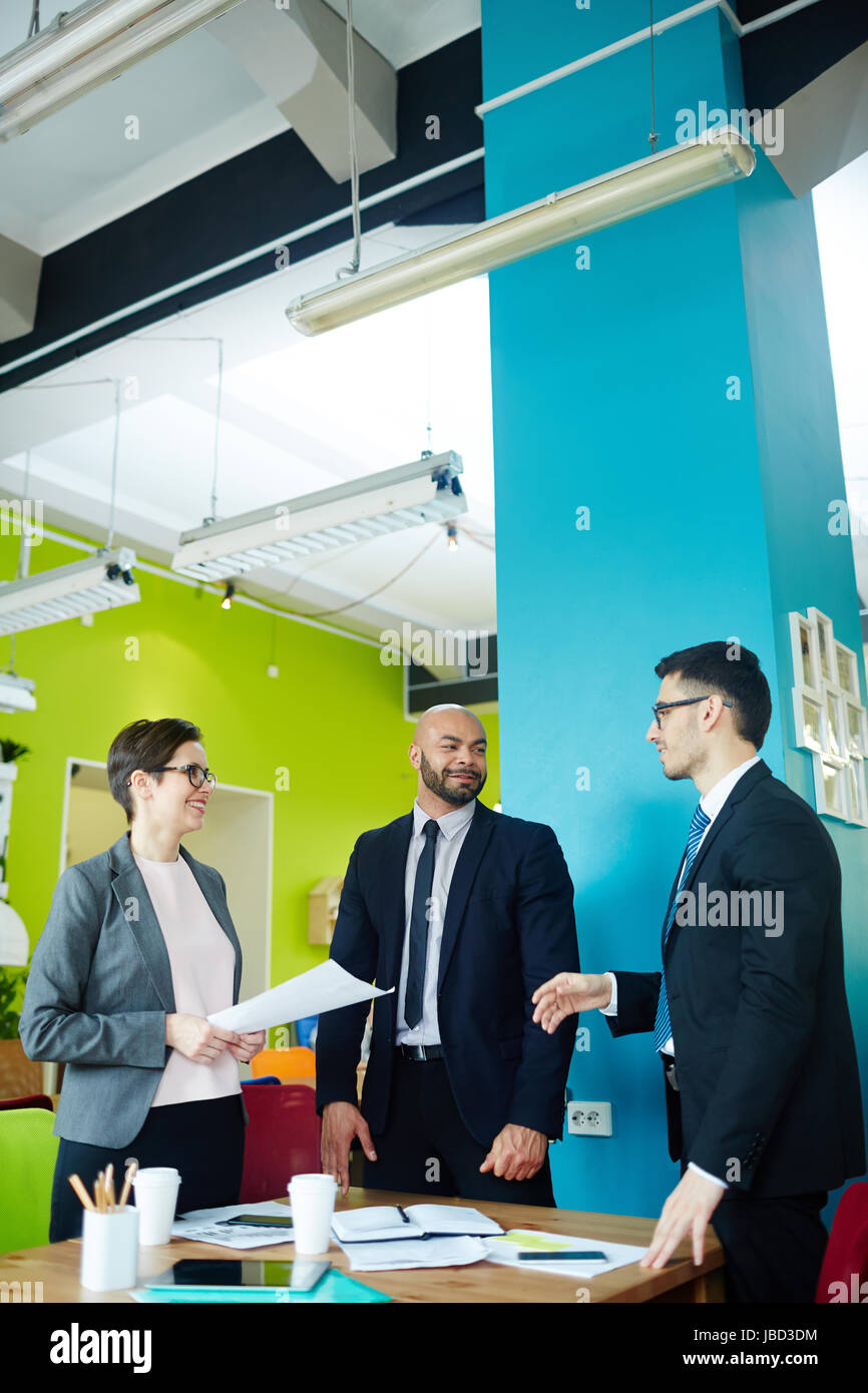 Happy staff having talk in studio Stock Photo - Alamy
