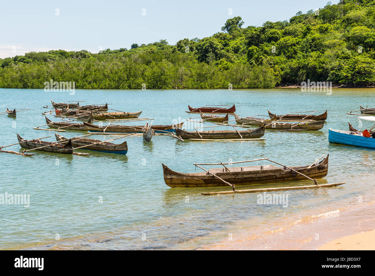 Traditional wooden dugout rowing outrigger canoes on Nosy Be island ...