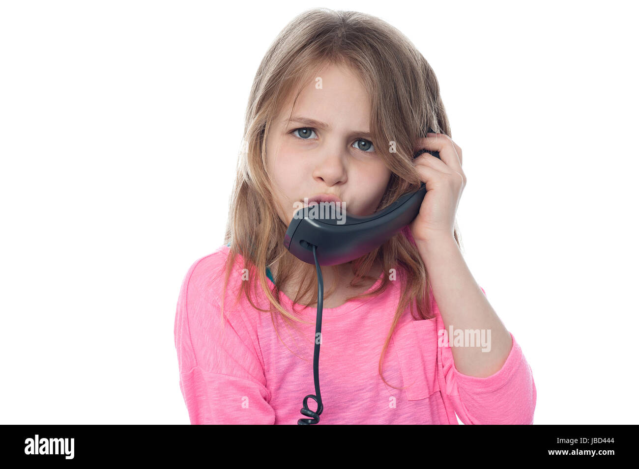 Confused kid attending phone call Stock Photo - Alamy
