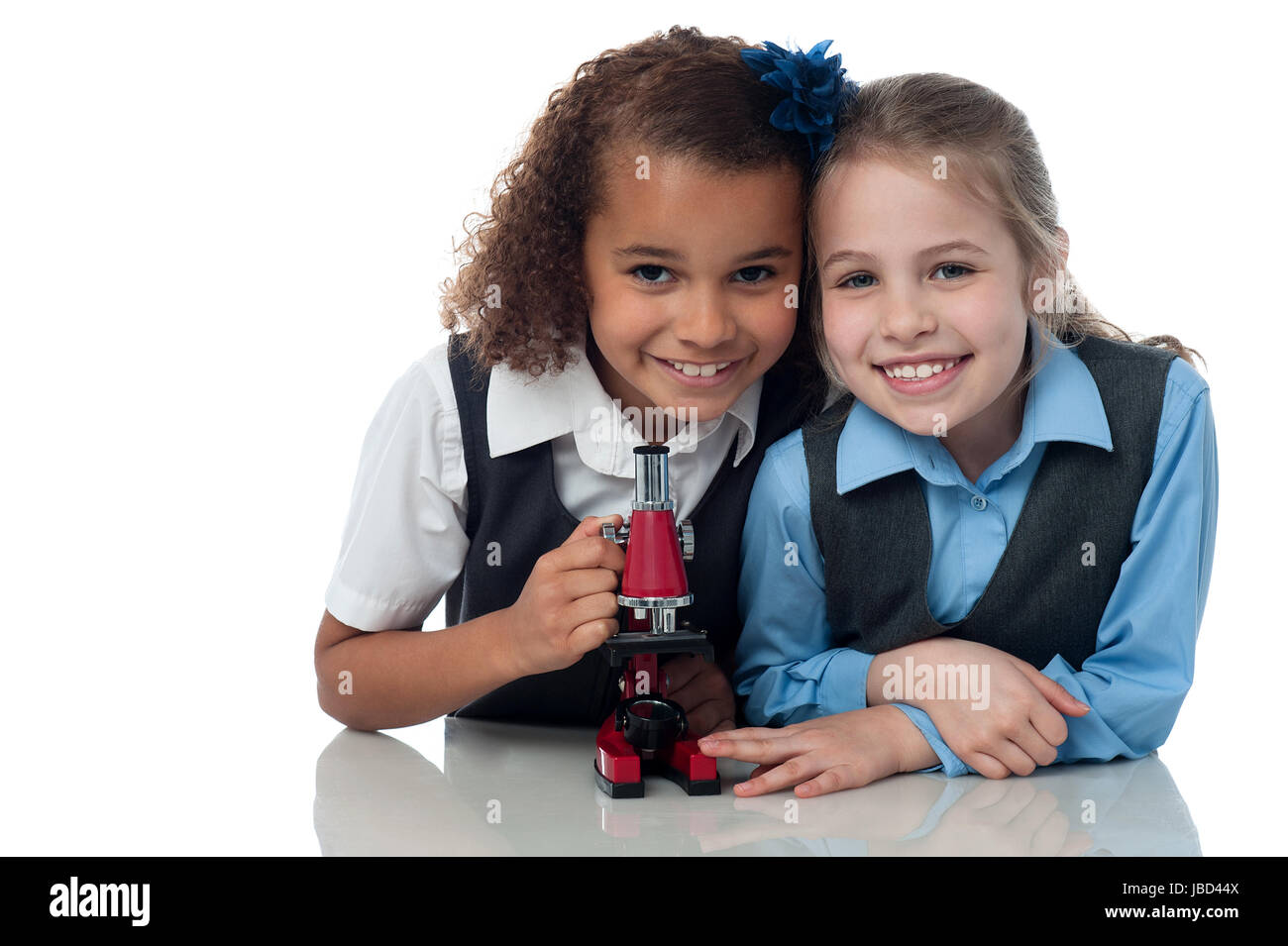School girls using microscope in science lab Stock Photo - Alamy