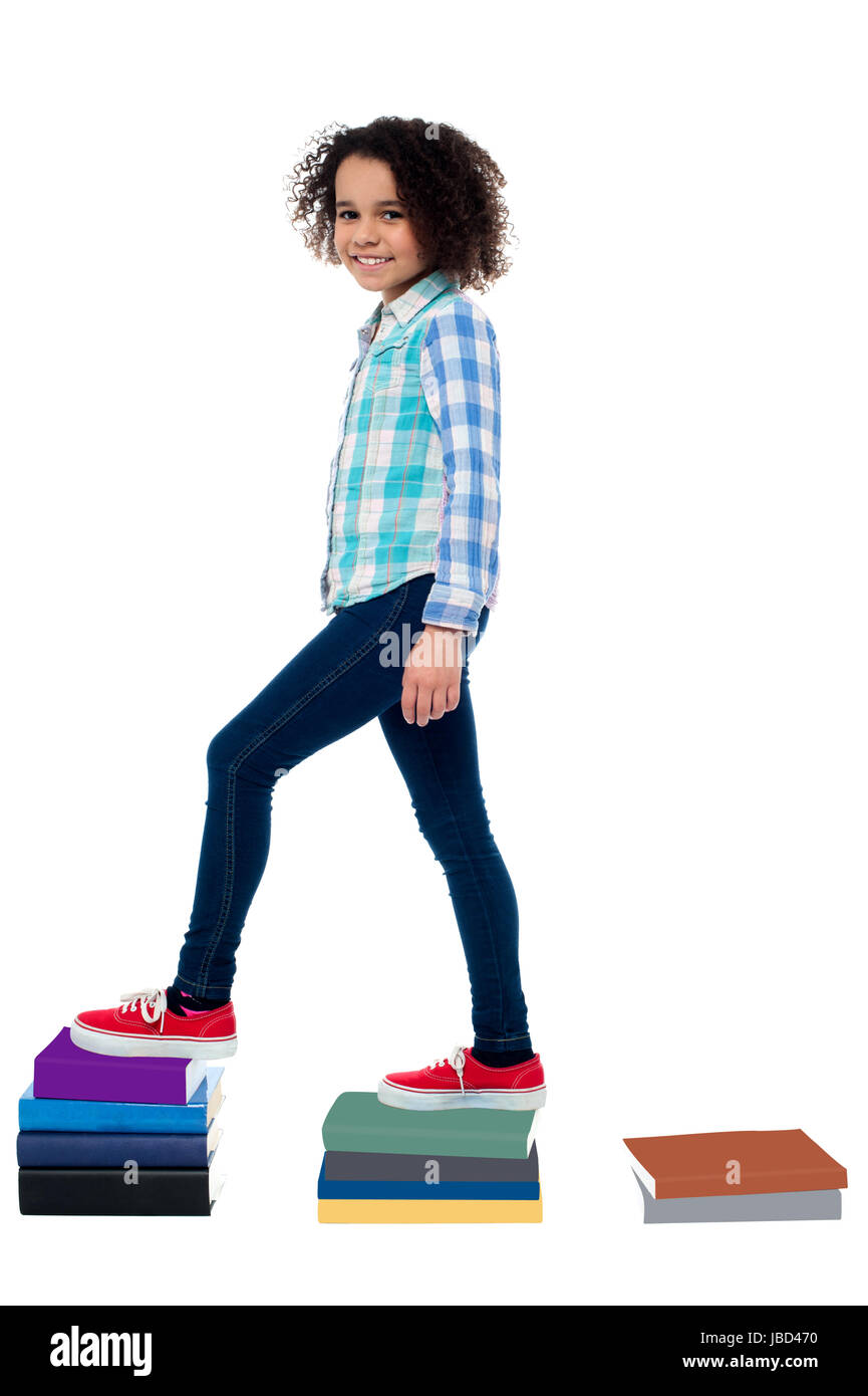 Pretty girl stepping over school books Stock Photo - Alamy