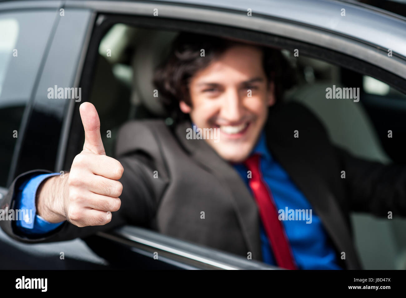 Man showing thumbs sign after completing test drive Stock Photo - Alamy