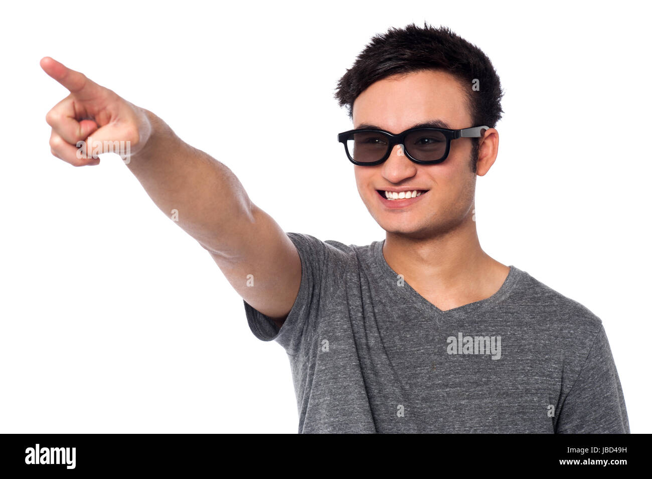 Young guy pointing something out, studio shot Stock Photo - Alamy