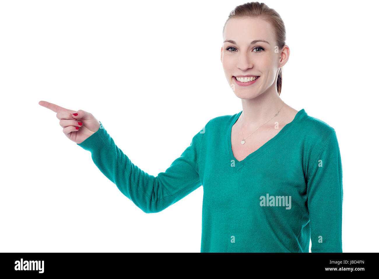 Young lady pointing towards copy space area Stock Photo - Alamy