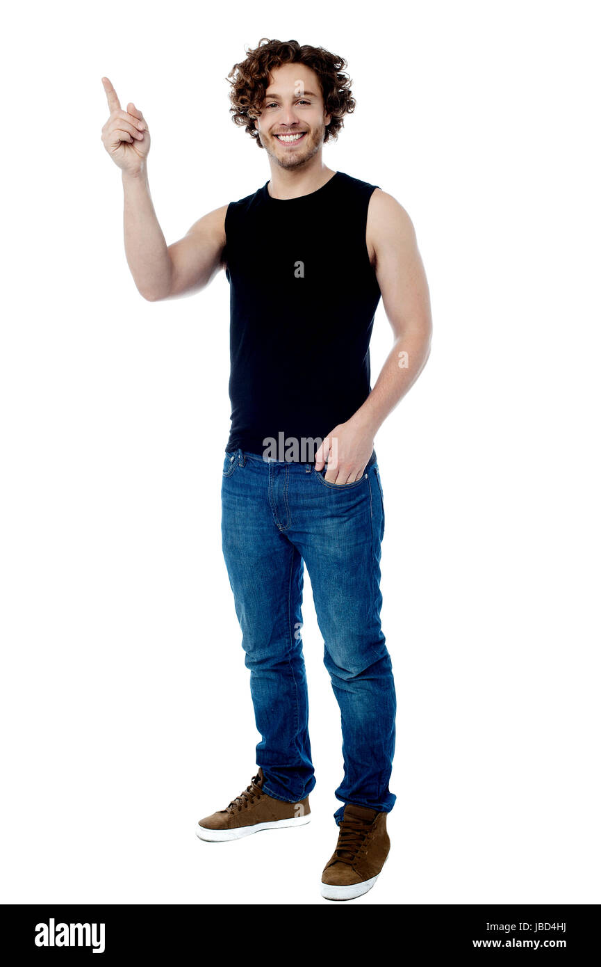 Smiling handsome man pointing upwards Stock Photo - Alamy