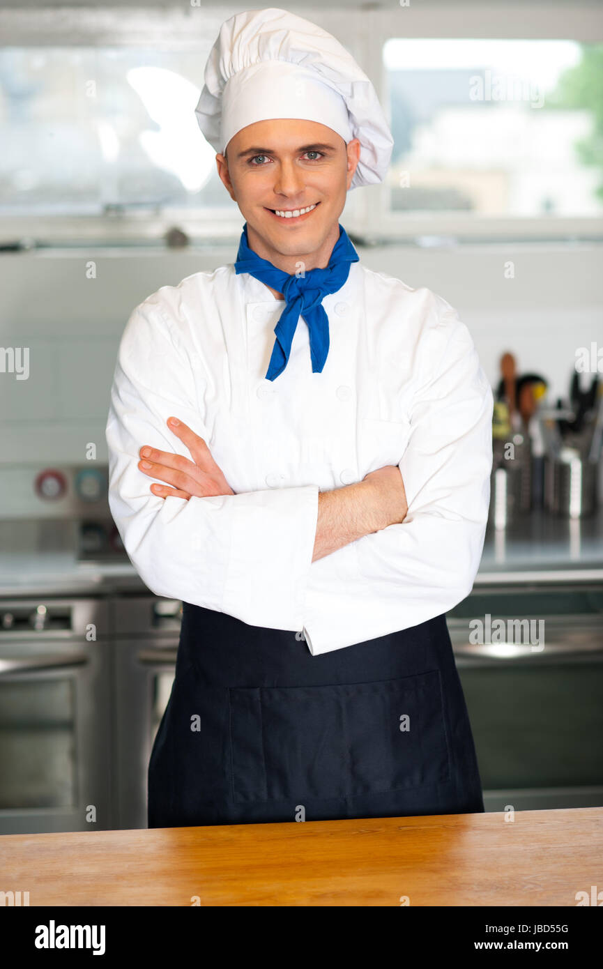 Confident young cook posing with arms crossed Stock Photo - Alamy