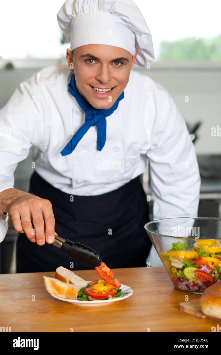 Chef busy in giving final touch to the dish Stock Photo - Alamy