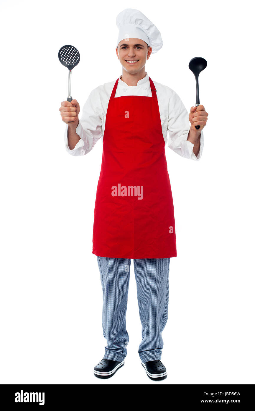Experienced chef displaying kitchen utensils Stock Photo - Alamy