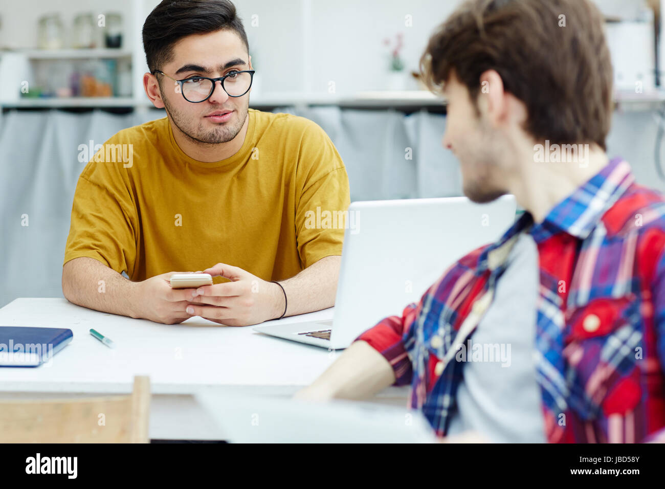 Attentive student listening to his groupmate during conversation Stock ...