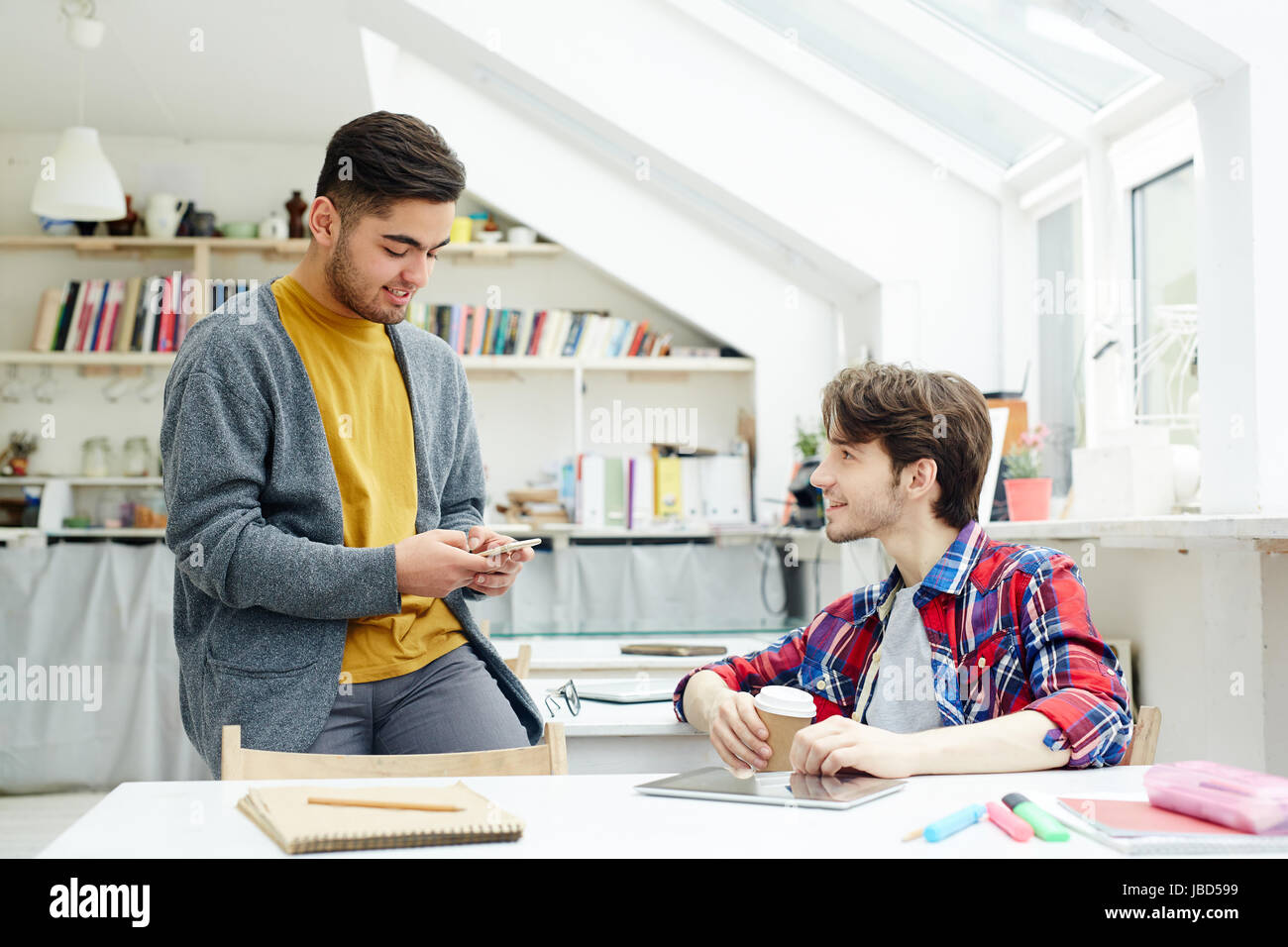 Friendly students having talk in classroom at break Stock Photo - Alamy