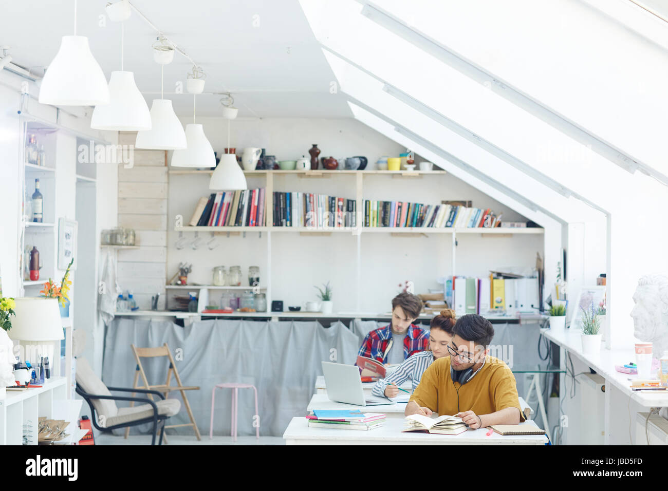 Row of students sitting by desks and writing test Stock Photo - Alamy