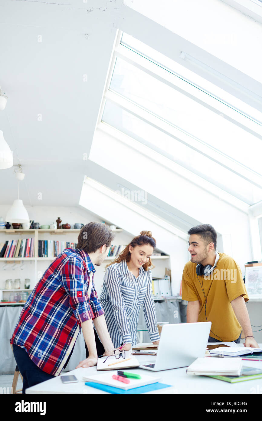 Friendly groupmates discussing project or assignment Stock Photo - Alamy