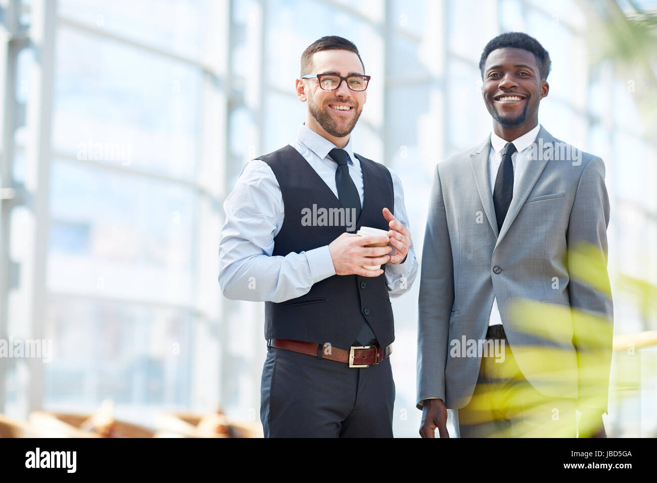 Intercultural men in formalwear looking at camera Stock Photo - Alamy