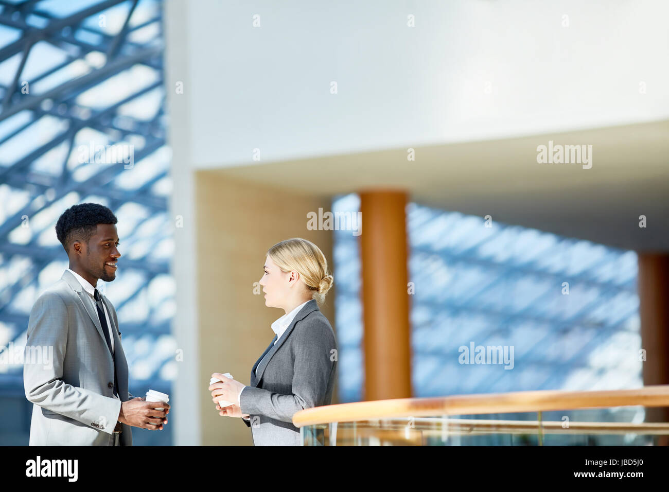 Coffee break of young managers in office building Stock Photo - Alamy