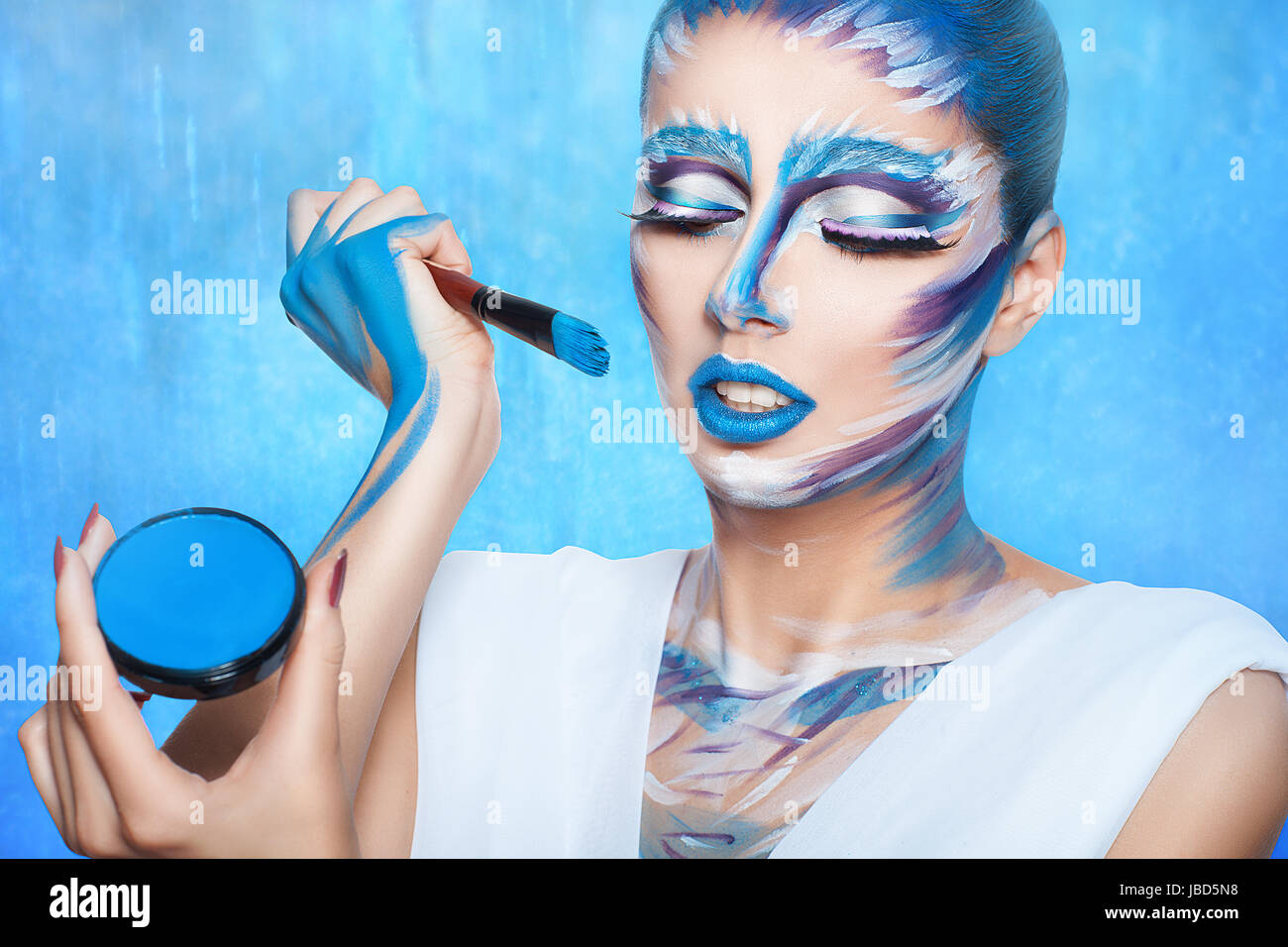 Portrait of paint on his face. In blue tones Stock Photo - Alamy