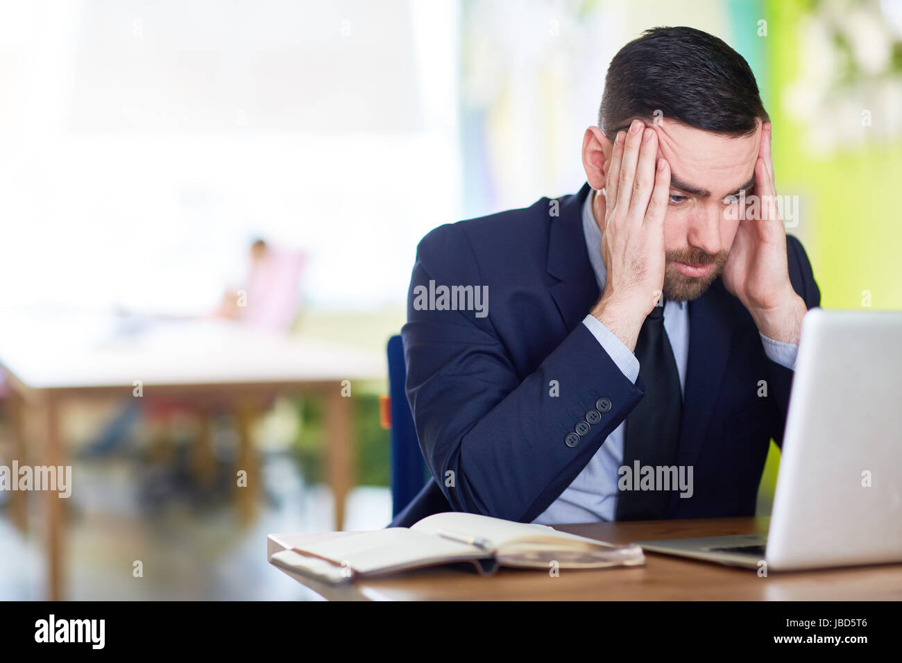 Businessman thinking of ideas in front of laptop Stock Photo - Alamy