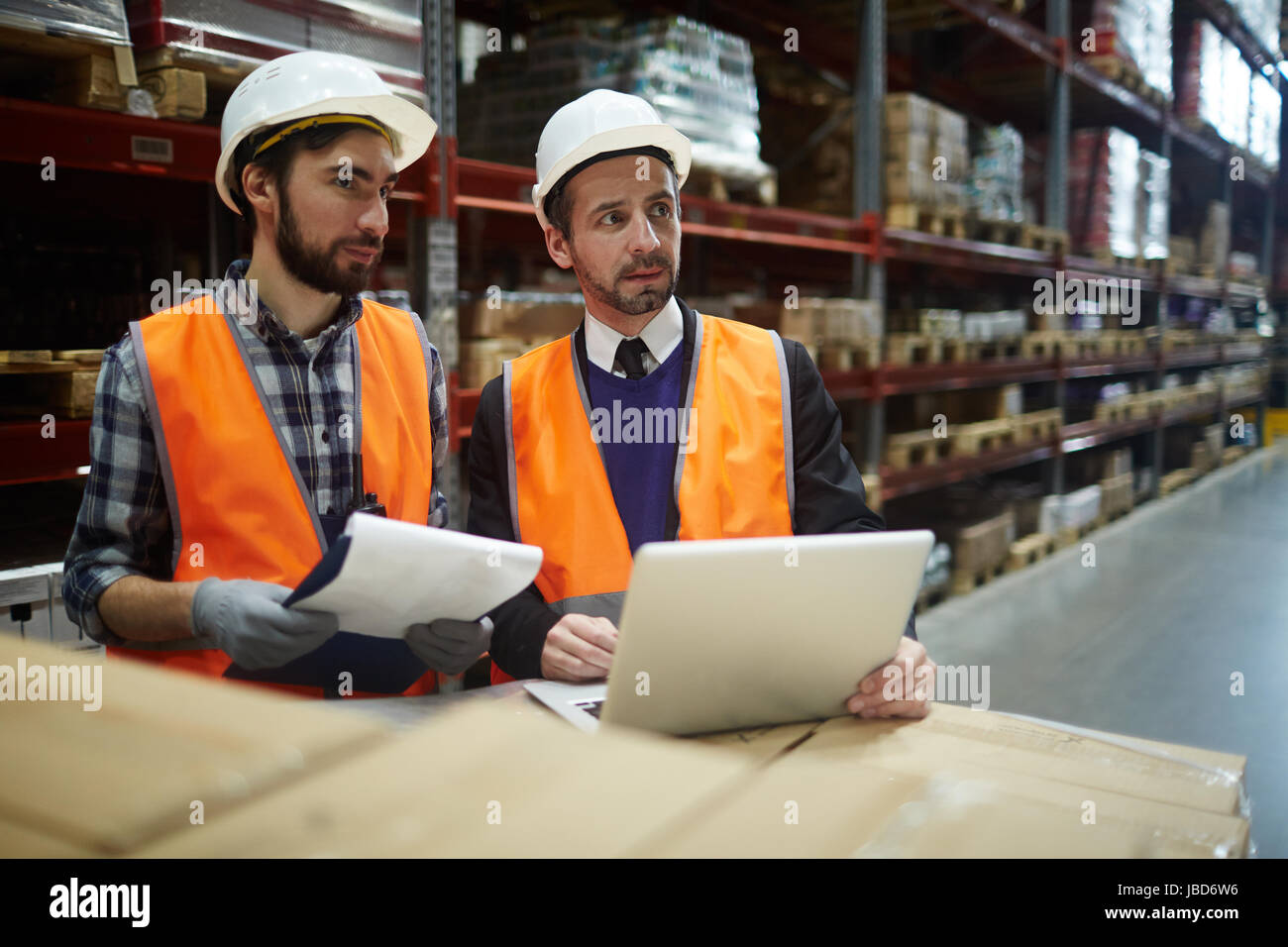Workers of warehouse making revision of goods Stock Photo - Alamy