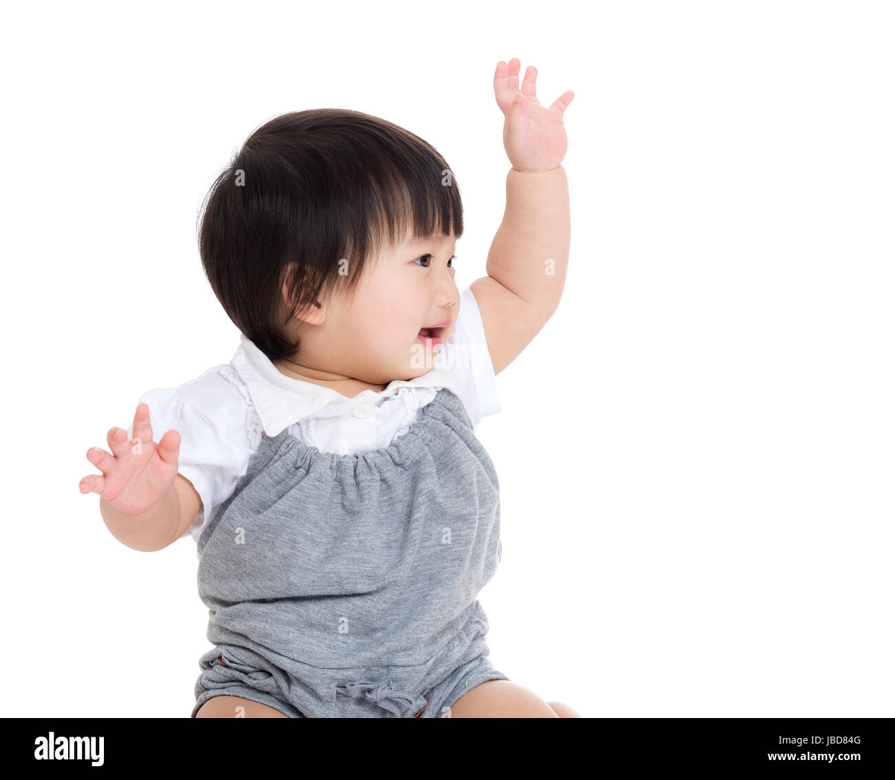 Asian baby girl greeting with hand up Stock Photo - Alamy