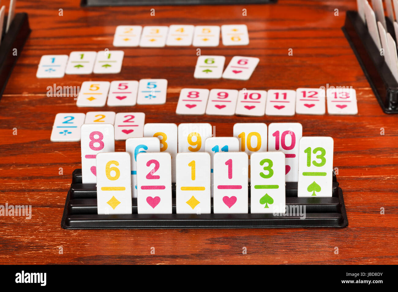 set of tiles in rack during playing in rummy game on wooden table Stock ...