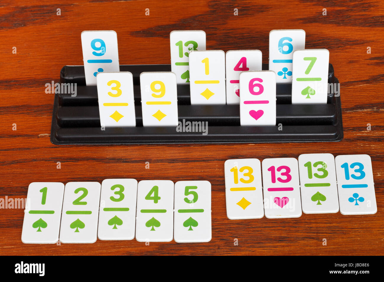 playing in rummy card game on wooden table - run and group of cards ...