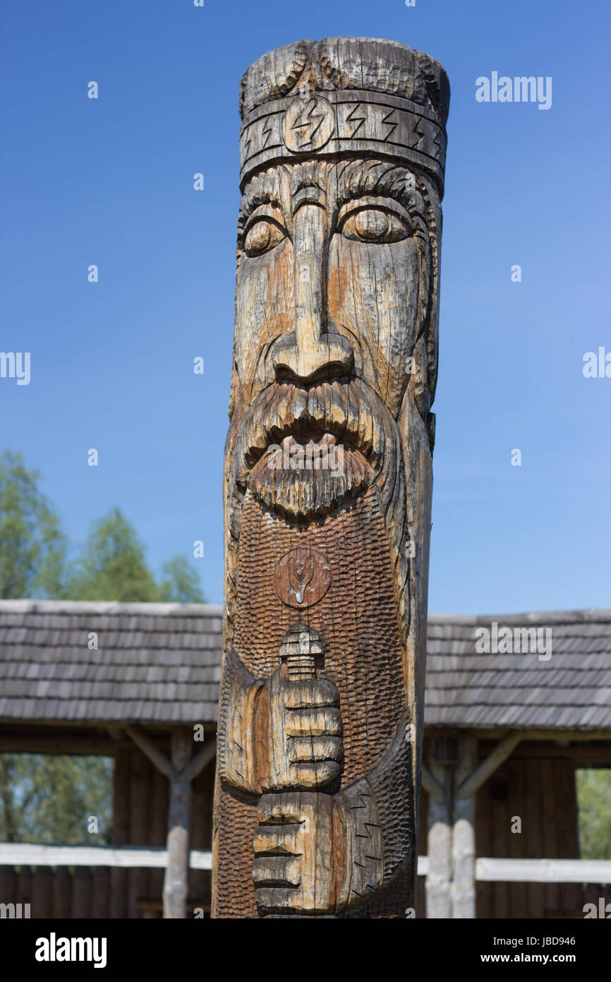 ancient pagan temple with wooden idol and house from tree bars in ...