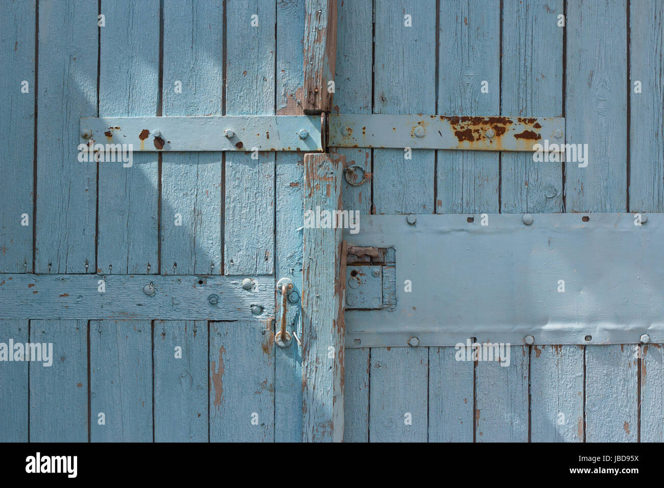 old light blue retro vintage wooden gates to garage with peeled ...