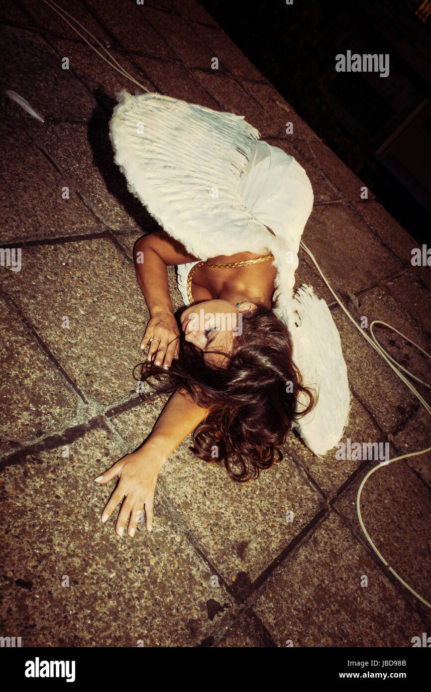 beautiful angel woman with white wings lie on roof Stock Photo - Alamy