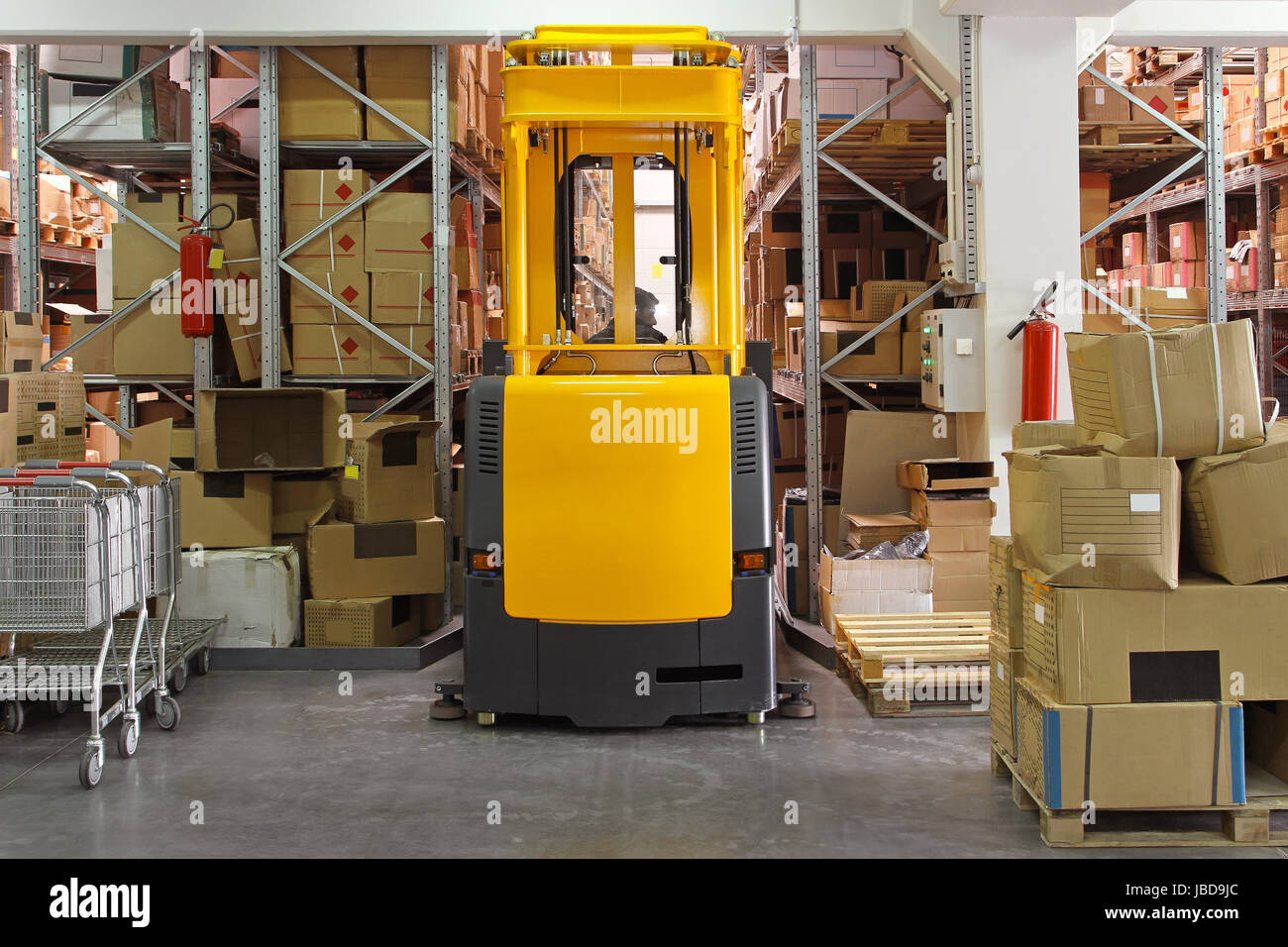 High rack stacker forklift truck in distribution warehouse Stock Photo ...