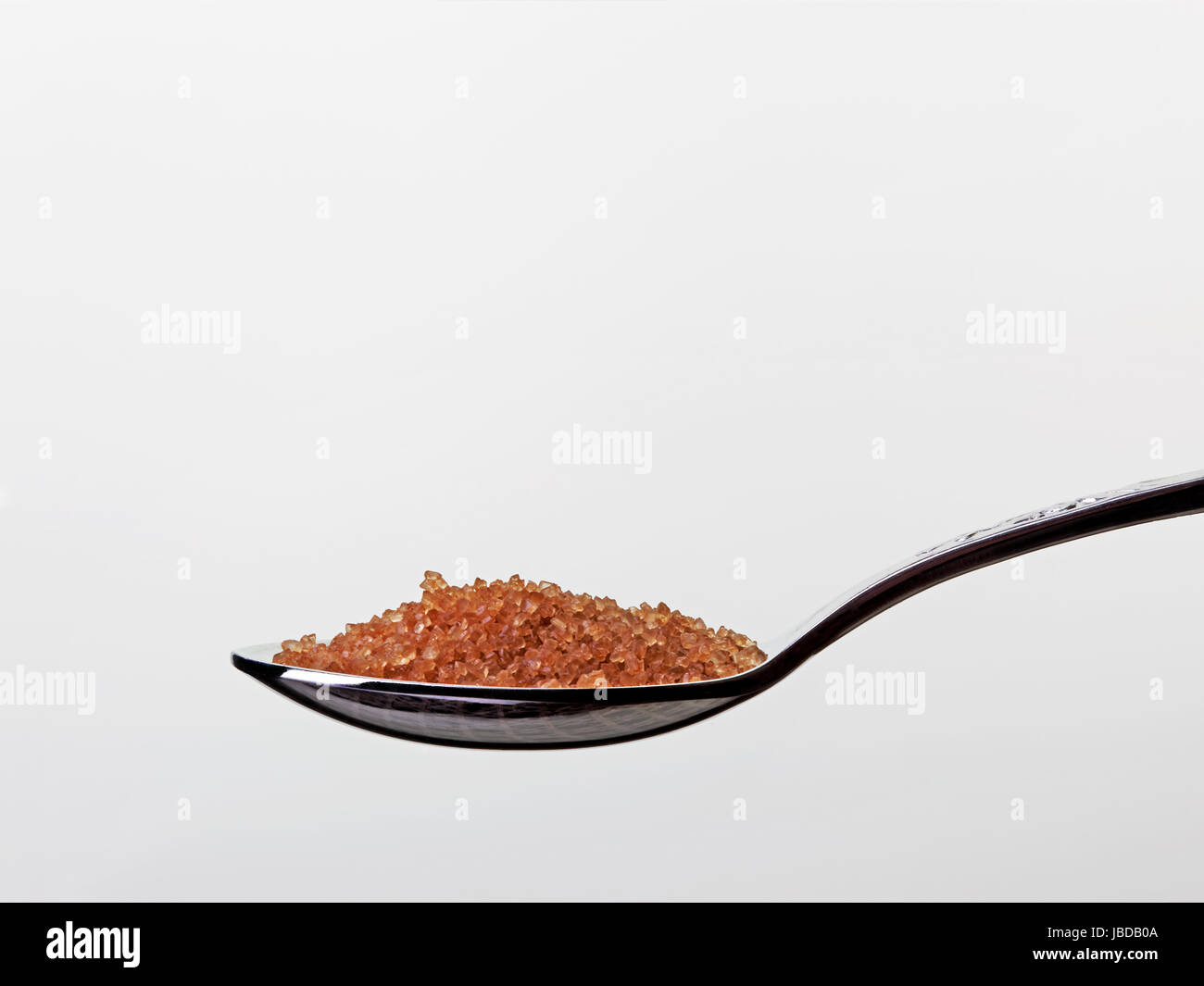 close up of a teaspoon with brown sugar, white background Stock Photo ...