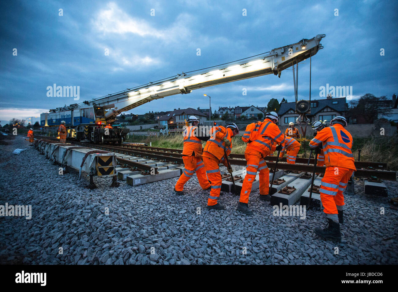 Rail construction workers laying new tracks Stock Photo - Alamy