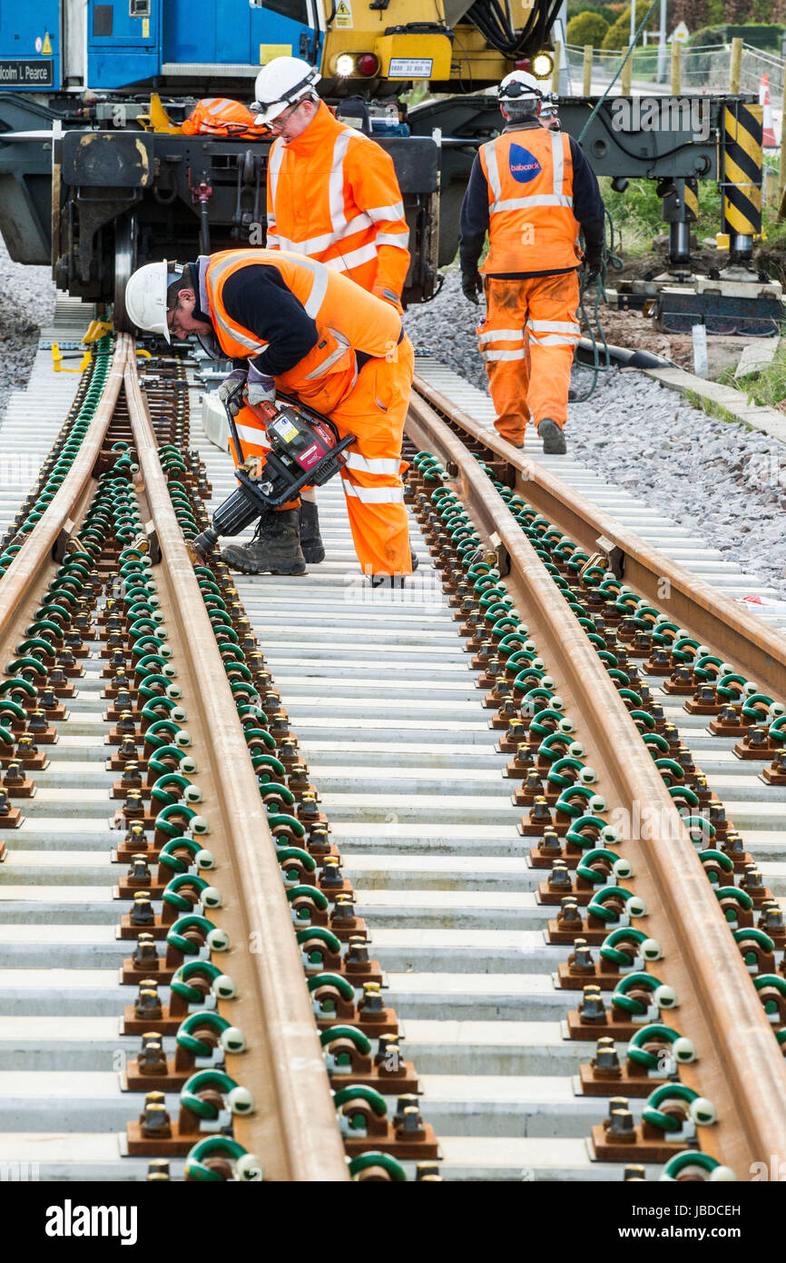 Rail construction workers laying new tracks Stock Photo - Alamy