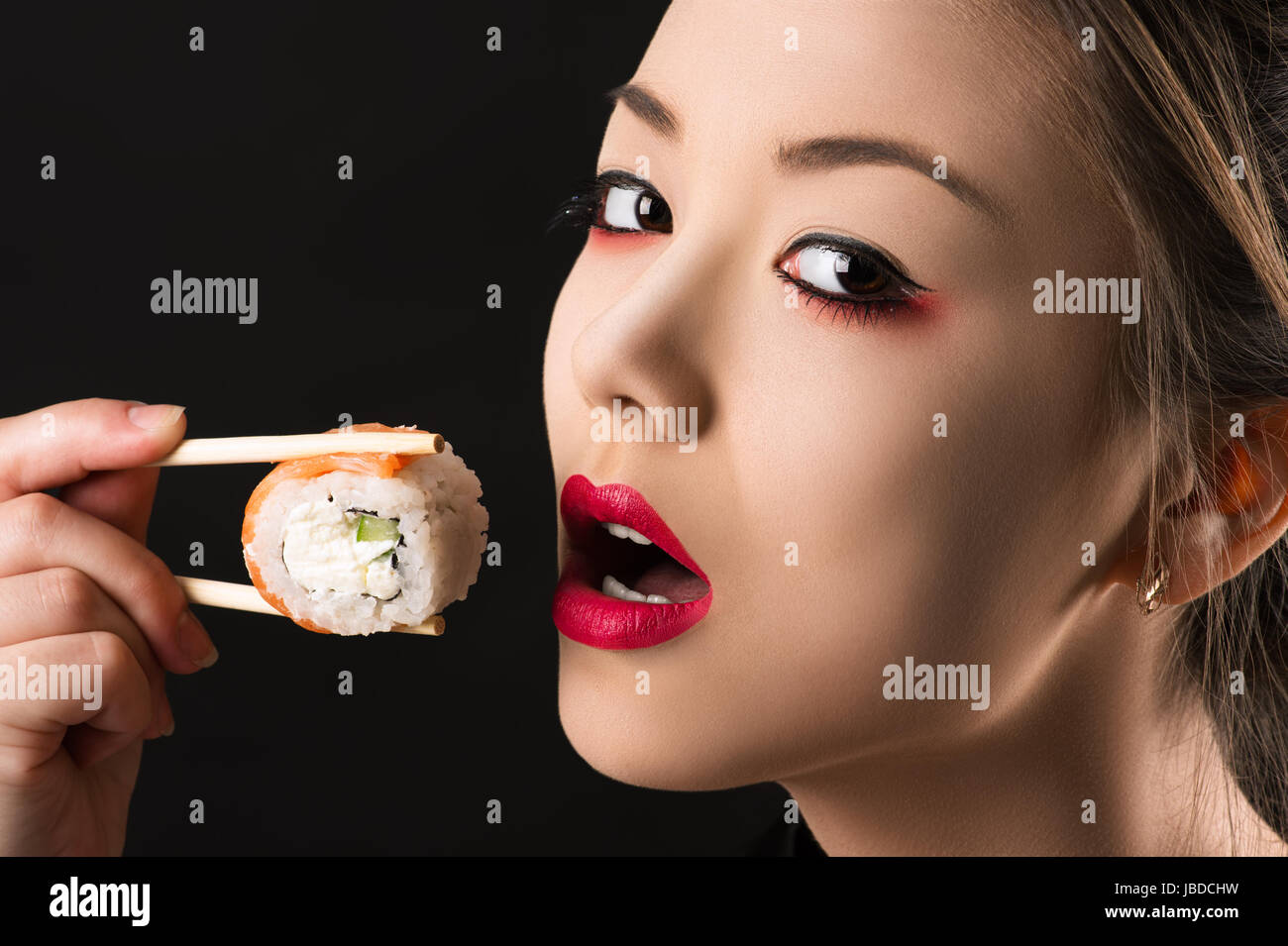 korean beautiful teenager girl with bright makeup eating a roll Stock ...
