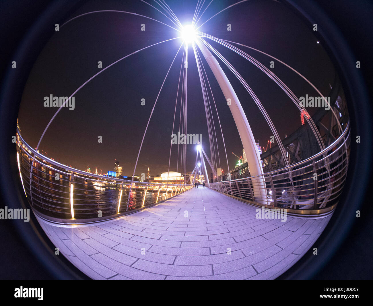 A fisheye lens view of people crossing Hungerford Bridge, London ...