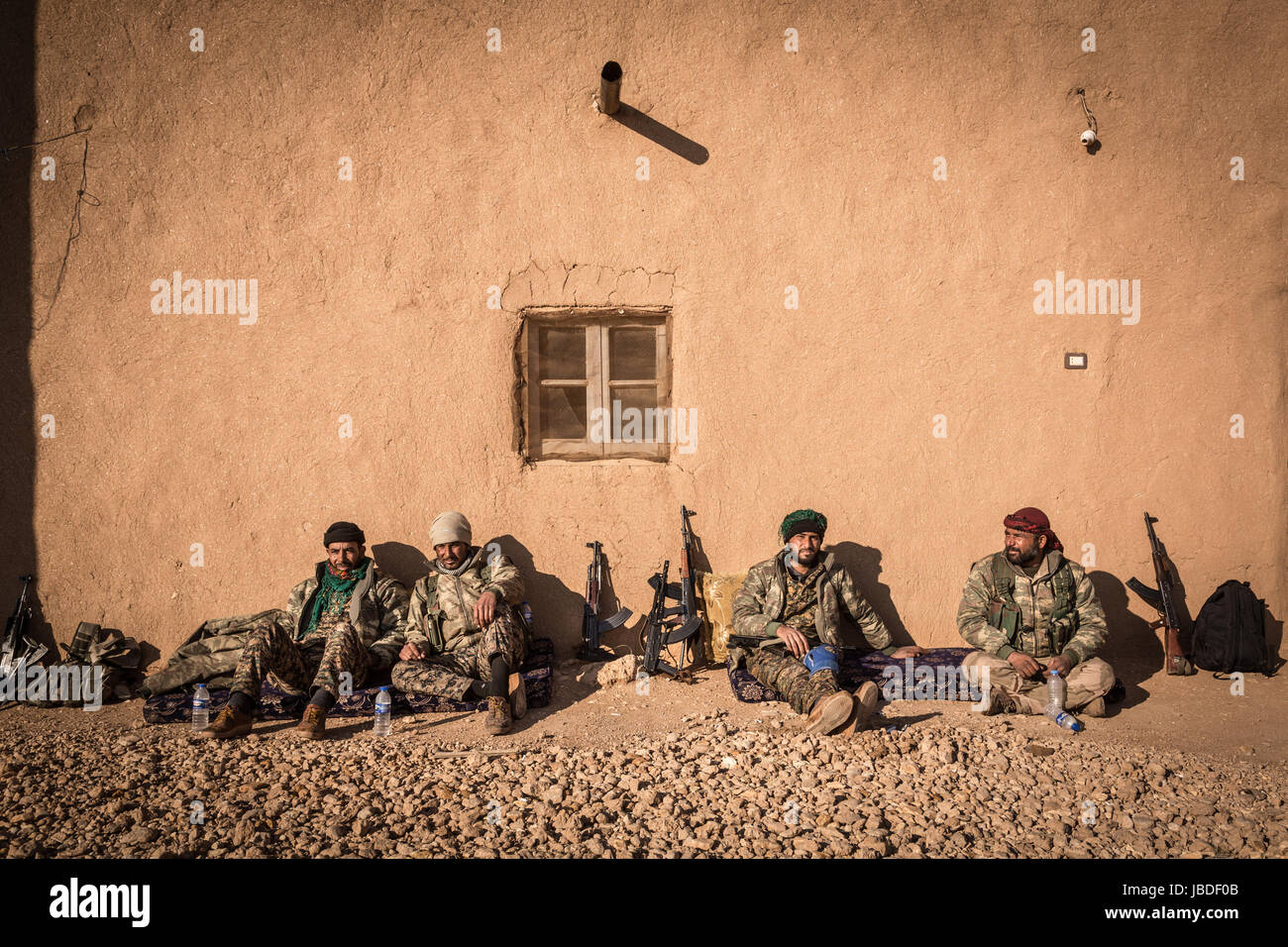 Soldier uniform rifle village desert hi-res stock photography and ...