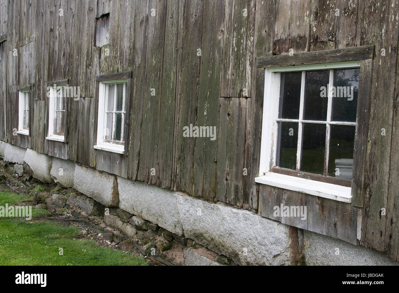 Antique wooden windows of an old abandoned barn. Weathered barn planks ...