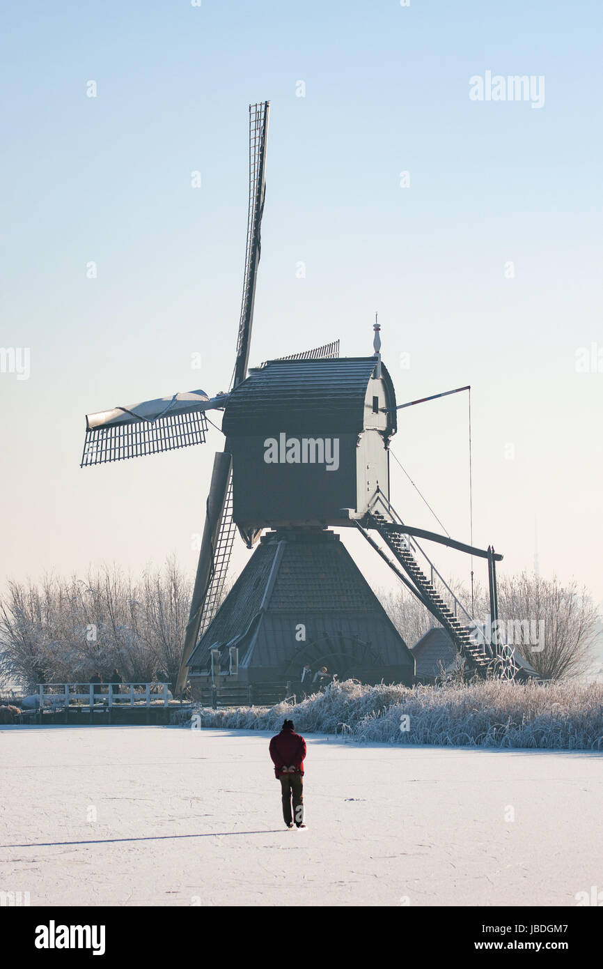KINDERDIJK, THE NETHERLANDS - A dutch winter landscape with a person ...