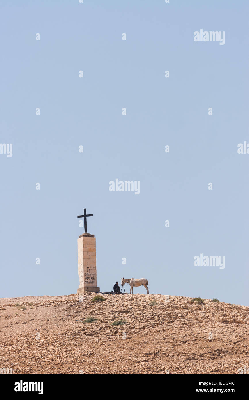 JERICHO, ISRAEL - Pilgrim resting in the shadow of a big christian ...