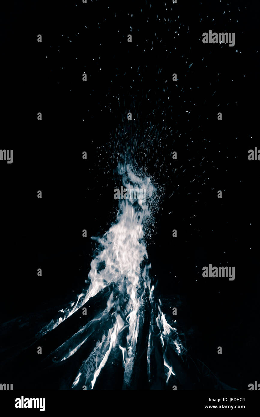 Blue bonfire with flying sparks isolated on black Stock Photo - Alamy