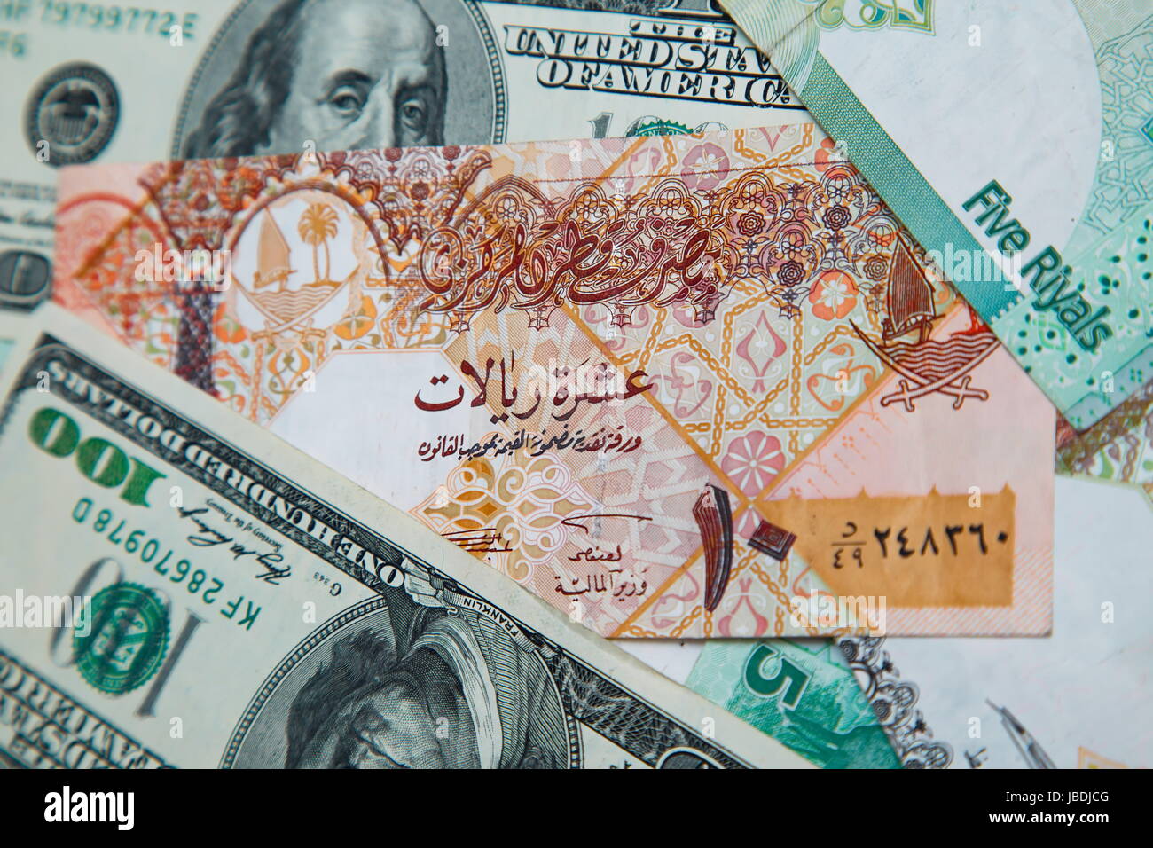 Qatari riyals and American dollars, close up Stock Photo - Alamy