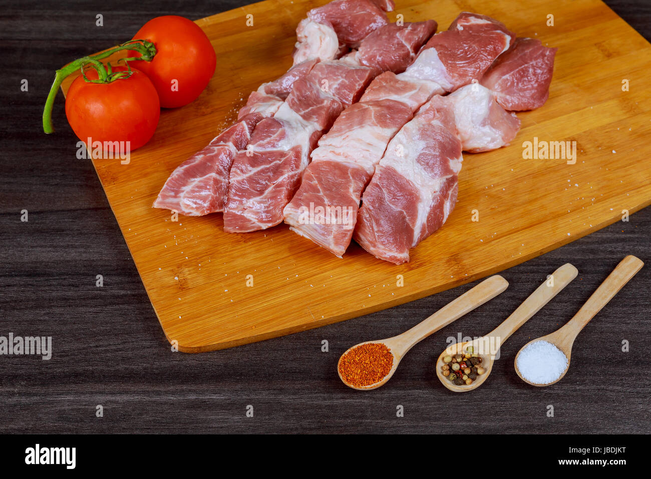 Fresh raw pork fat ready for gammoning on wooden cutting board, spices ...