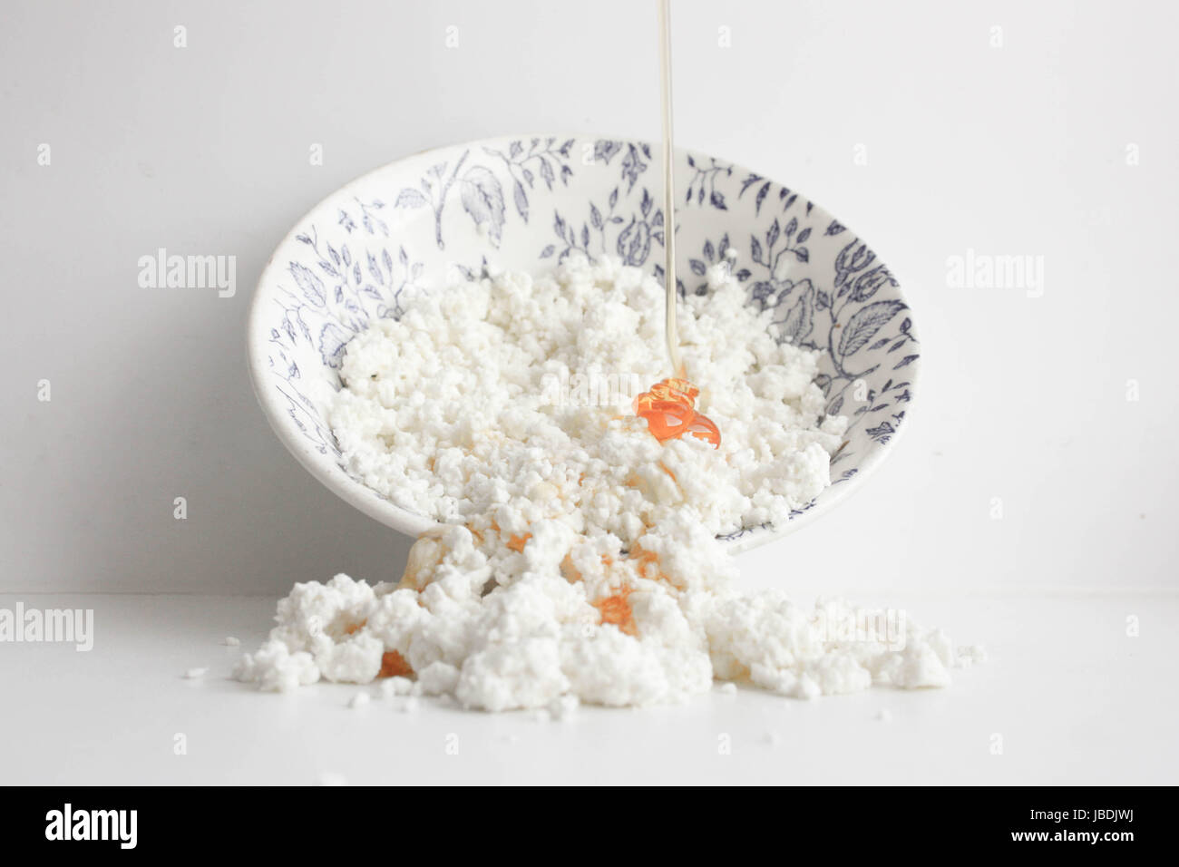 Curd in a plate with honey on a white background. Photo for your design ...