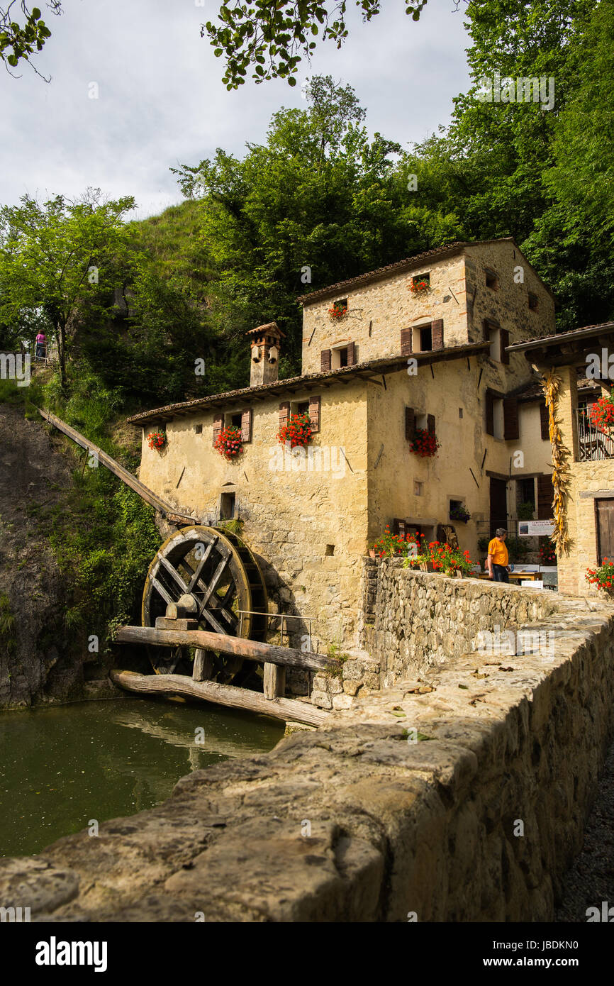 Colorful cottage with water mill Stock Photo - Alamy